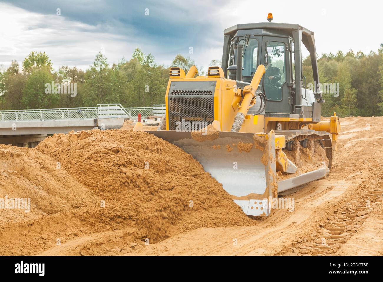 Bulldozer moves sand Stock Photo - Alamy