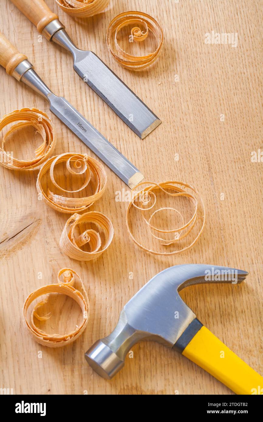 Chisel and claw hammer with wood shavings on board Stock Photo - Alamy