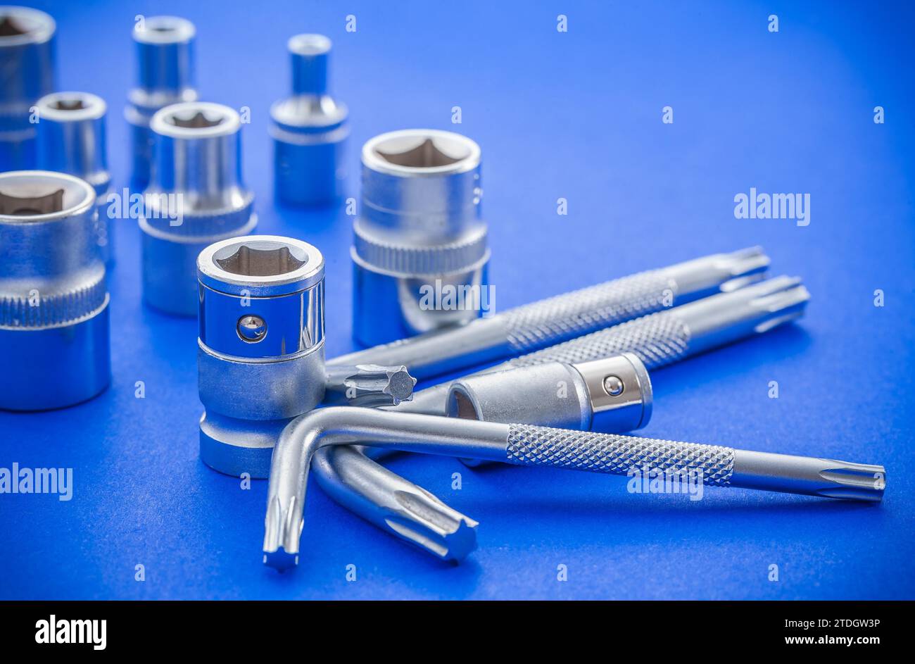 Hexagon spanner and Torx on blue background Stock Photo - Alamy