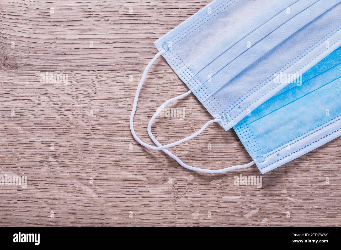 Medical surgical flu masks Textile filter on wooden plate Stock Photo ...