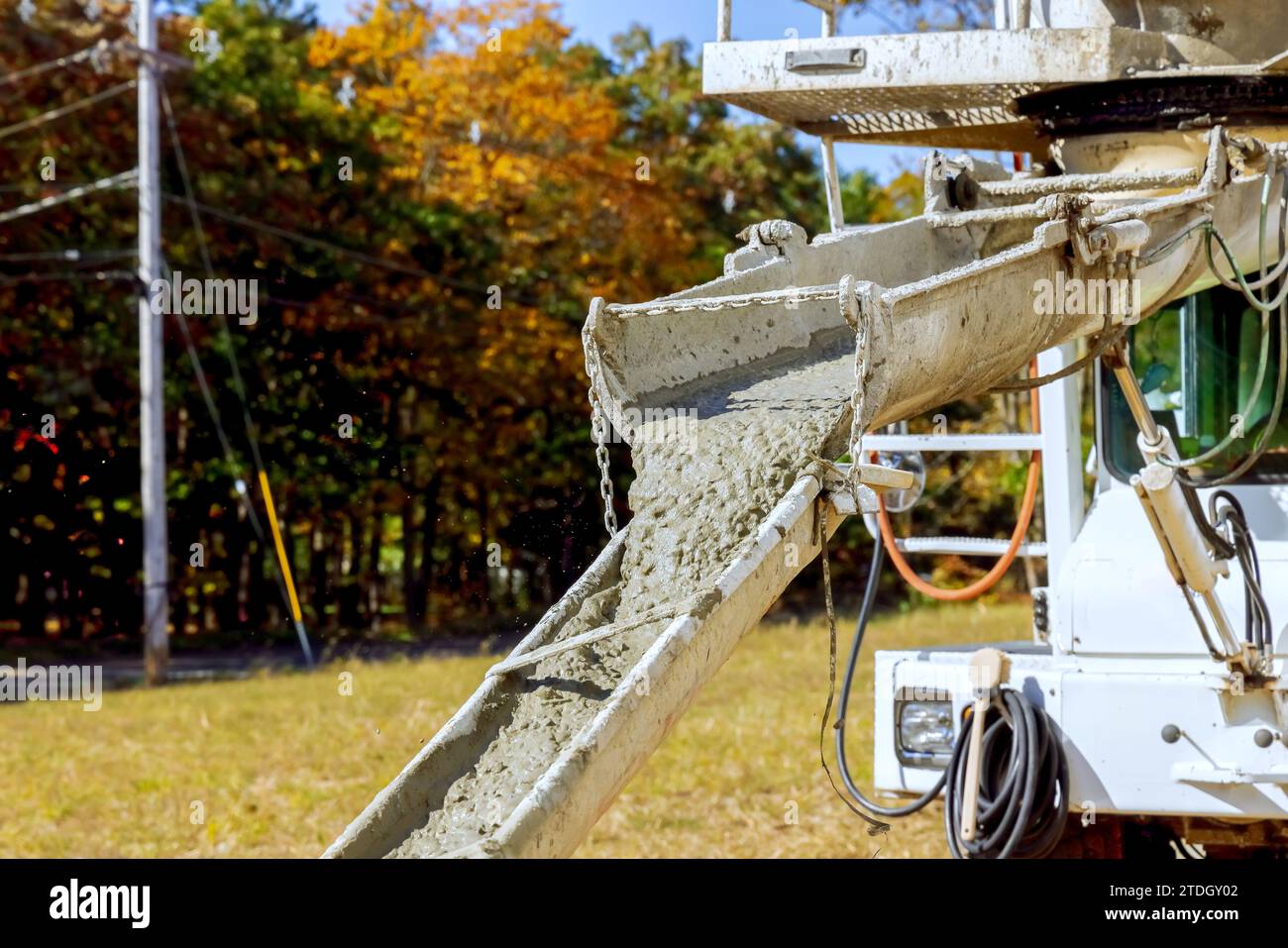 Concrete mixer truck poured liquid cement concrete at construction site ...