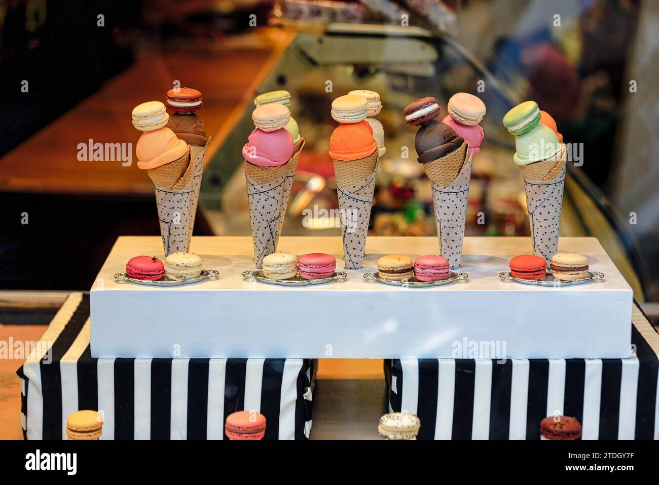 Five ice-cream cones next to each other, macarons, decoration in shop ...