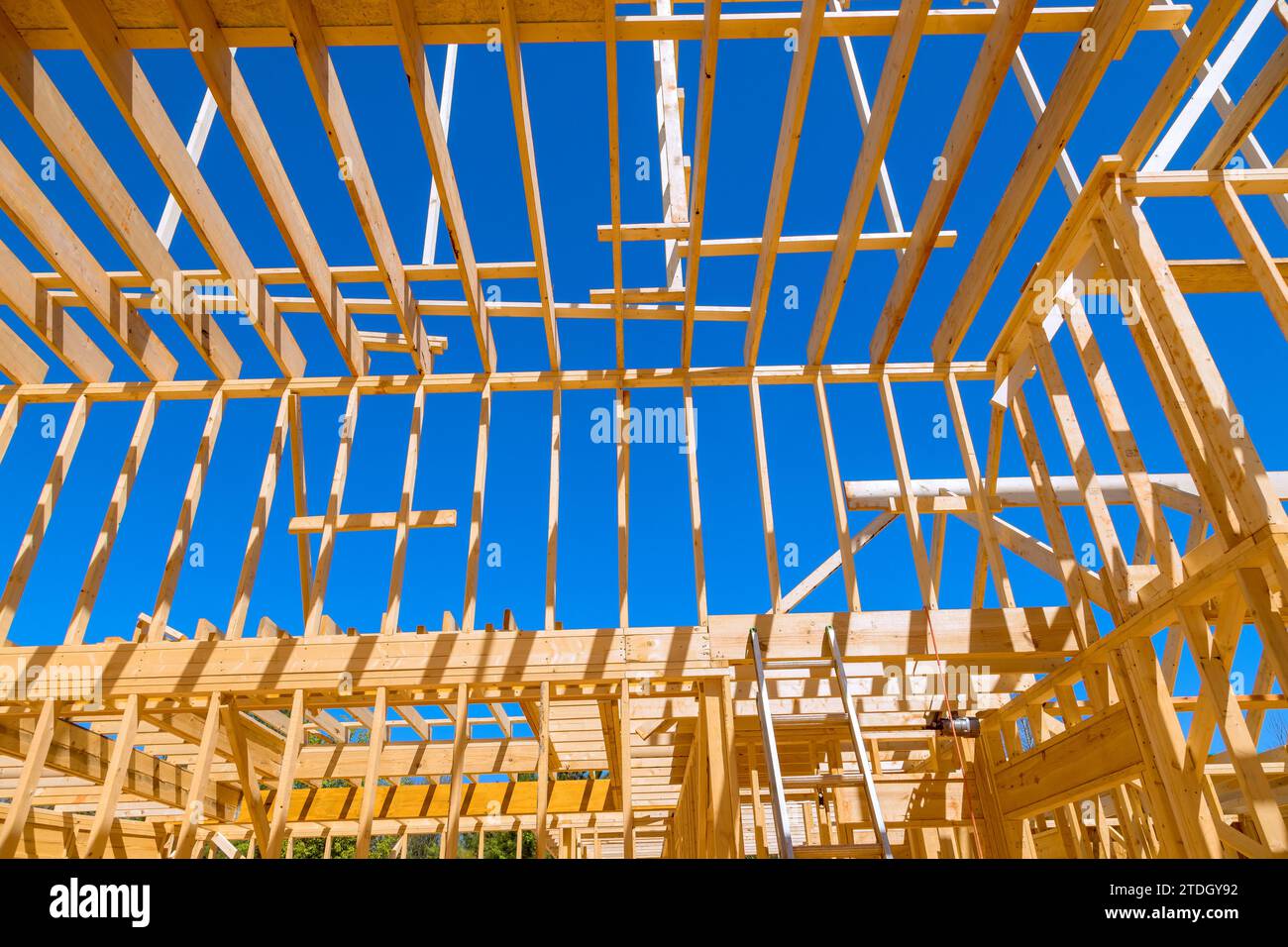 Wooden support beams in frame trusses roof construction for new house ...