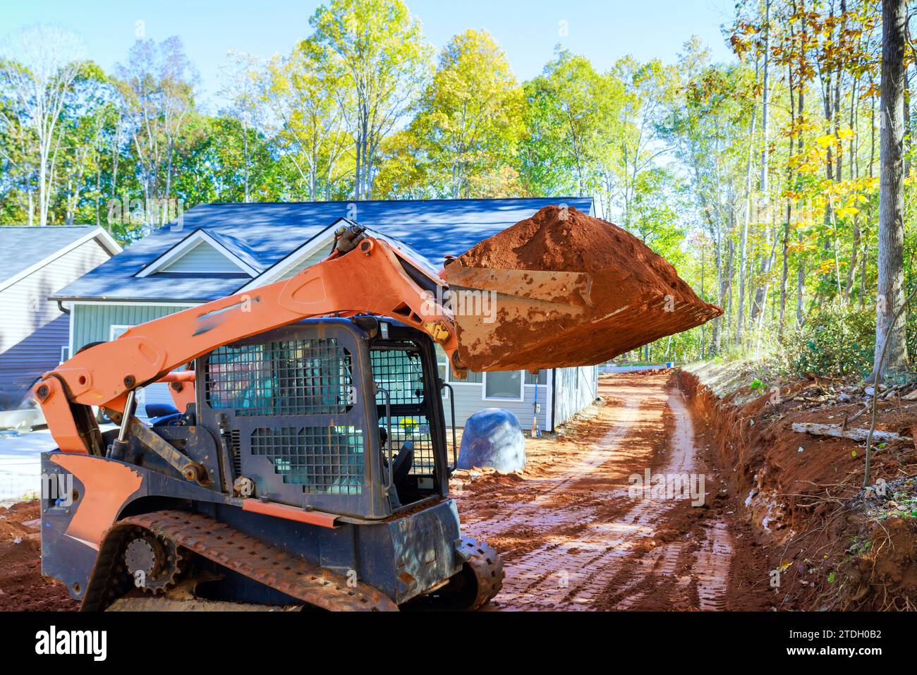 An earth moving mini bulldozer is being used for landscaping tasks ...