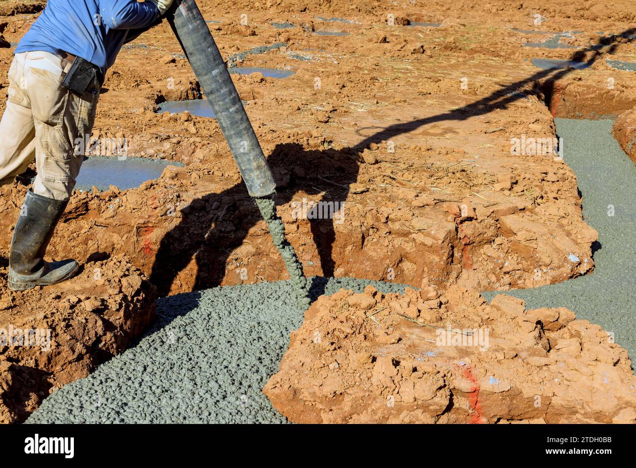 Pouring concrete foundation for new house at construction site by ...