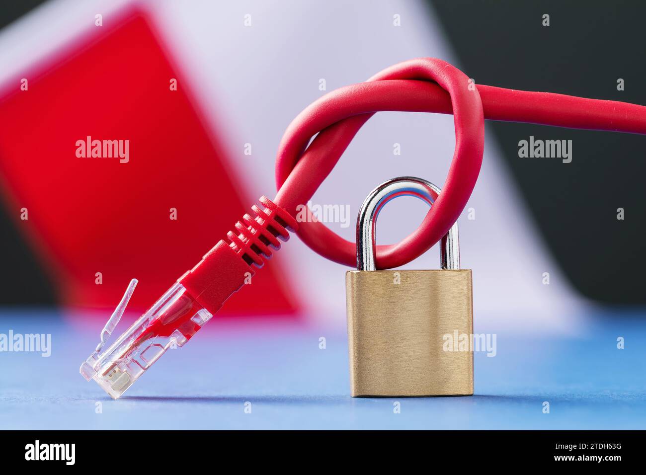 A closed lock on a tied network wire into a knot against the background ...