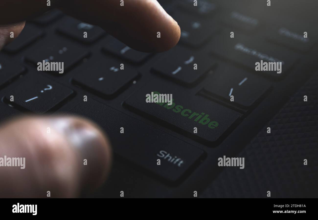 Close-up photo captures a hand clicking the Subscribe button ...