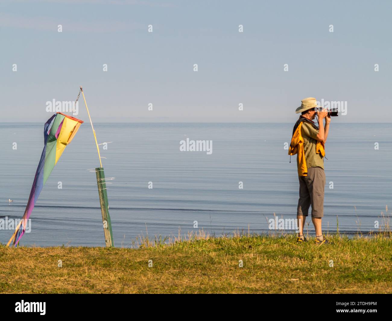 A man (myself) photographs the landscape in front of the Saint-Laurent ...