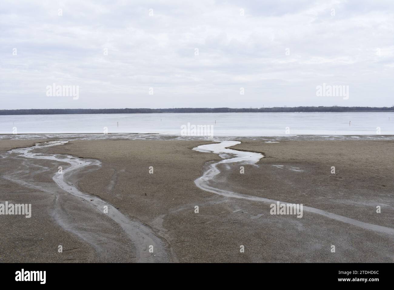 Image of melting rivers of ice in sand along the frozen water Stock ...