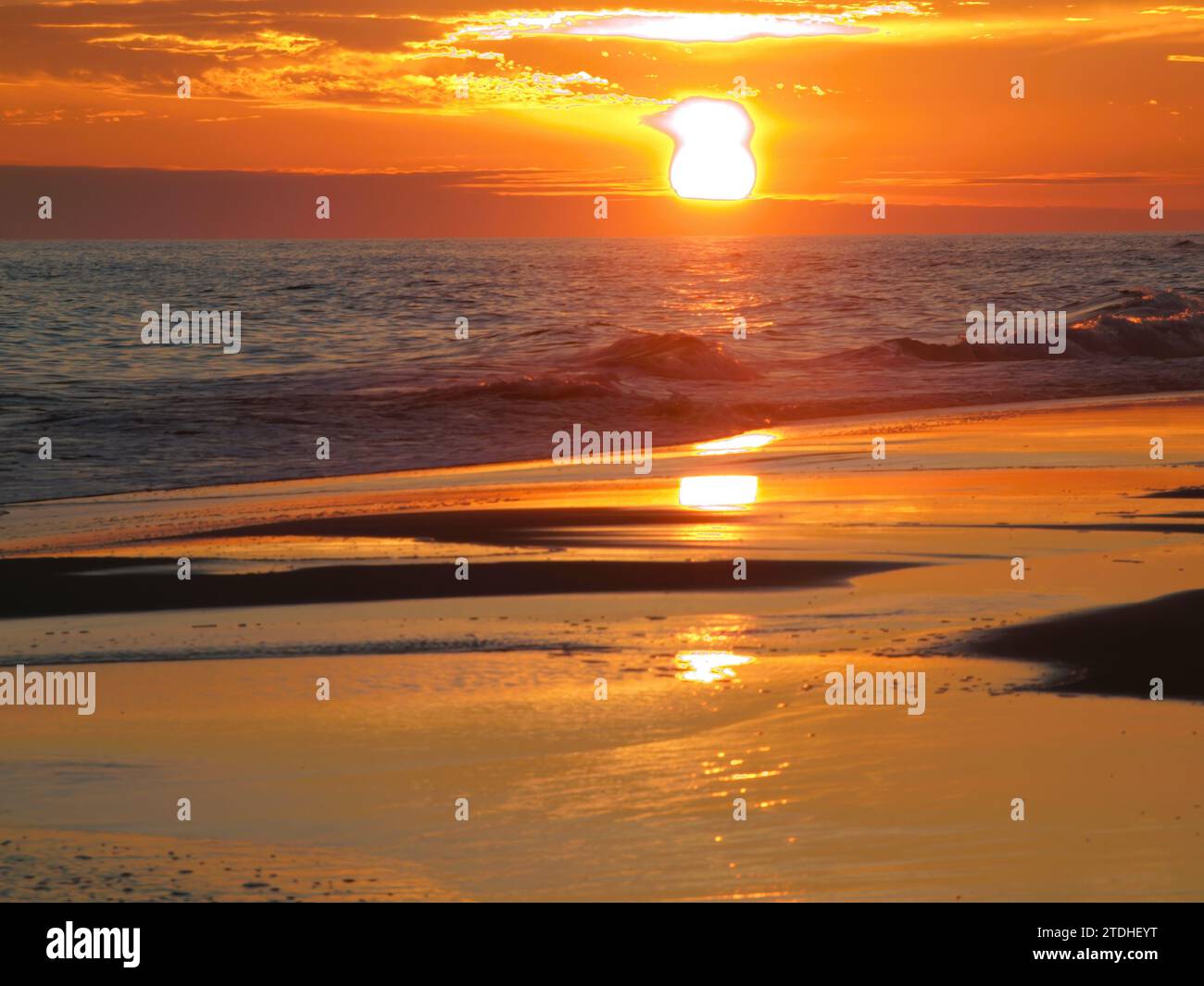Three sun sunsets reflections Stock Photo - Alamy