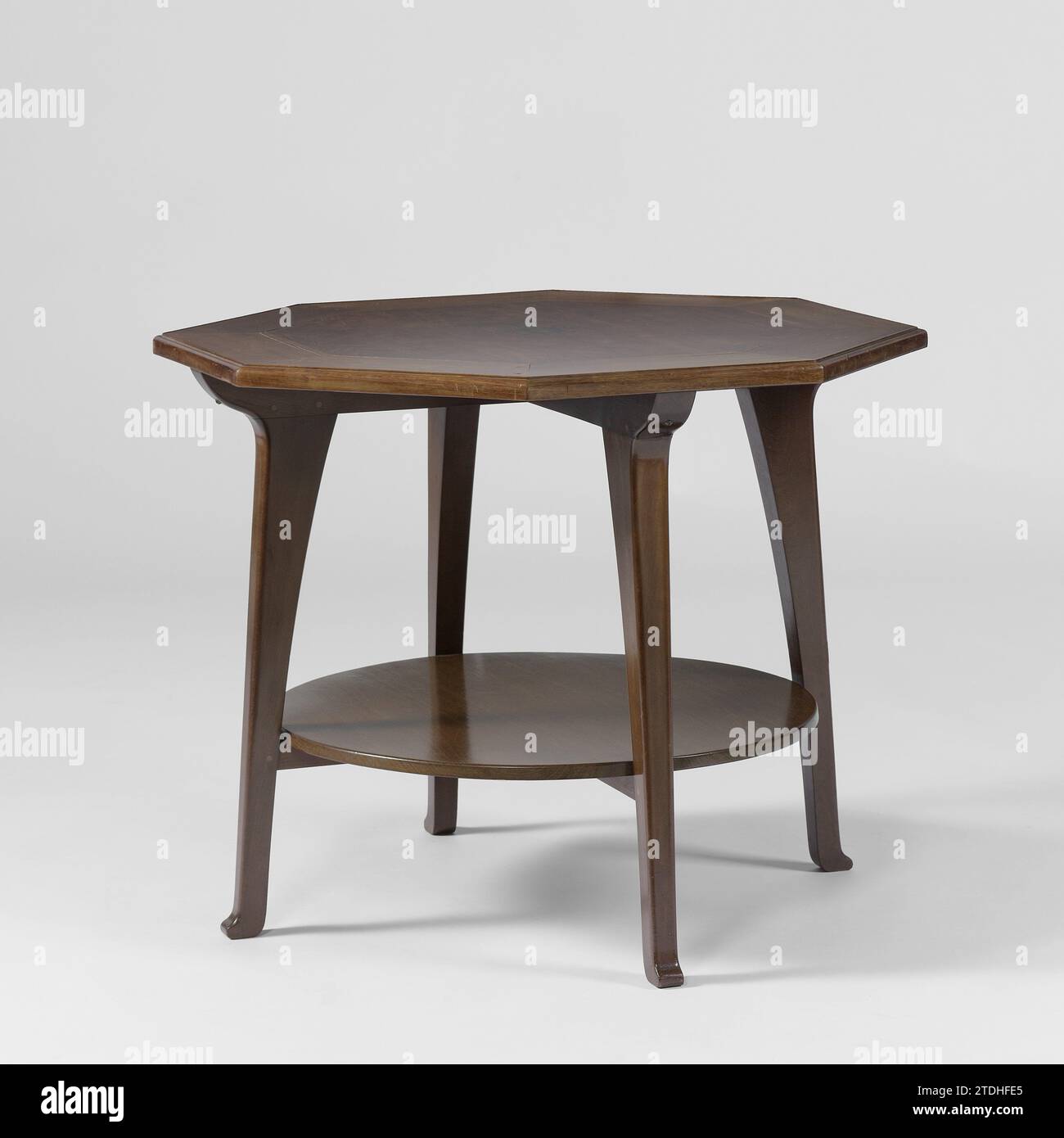 Table with an octagonal table top and resting on four bragged legs ...