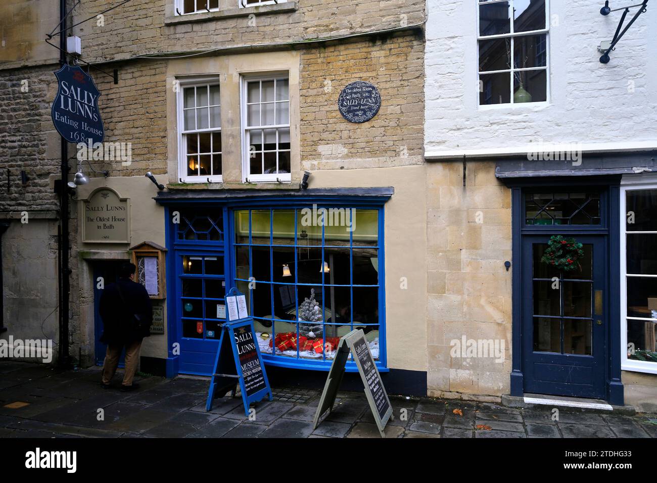 Man looking at menu board outside Sally Lunn's Eating House. December ...
