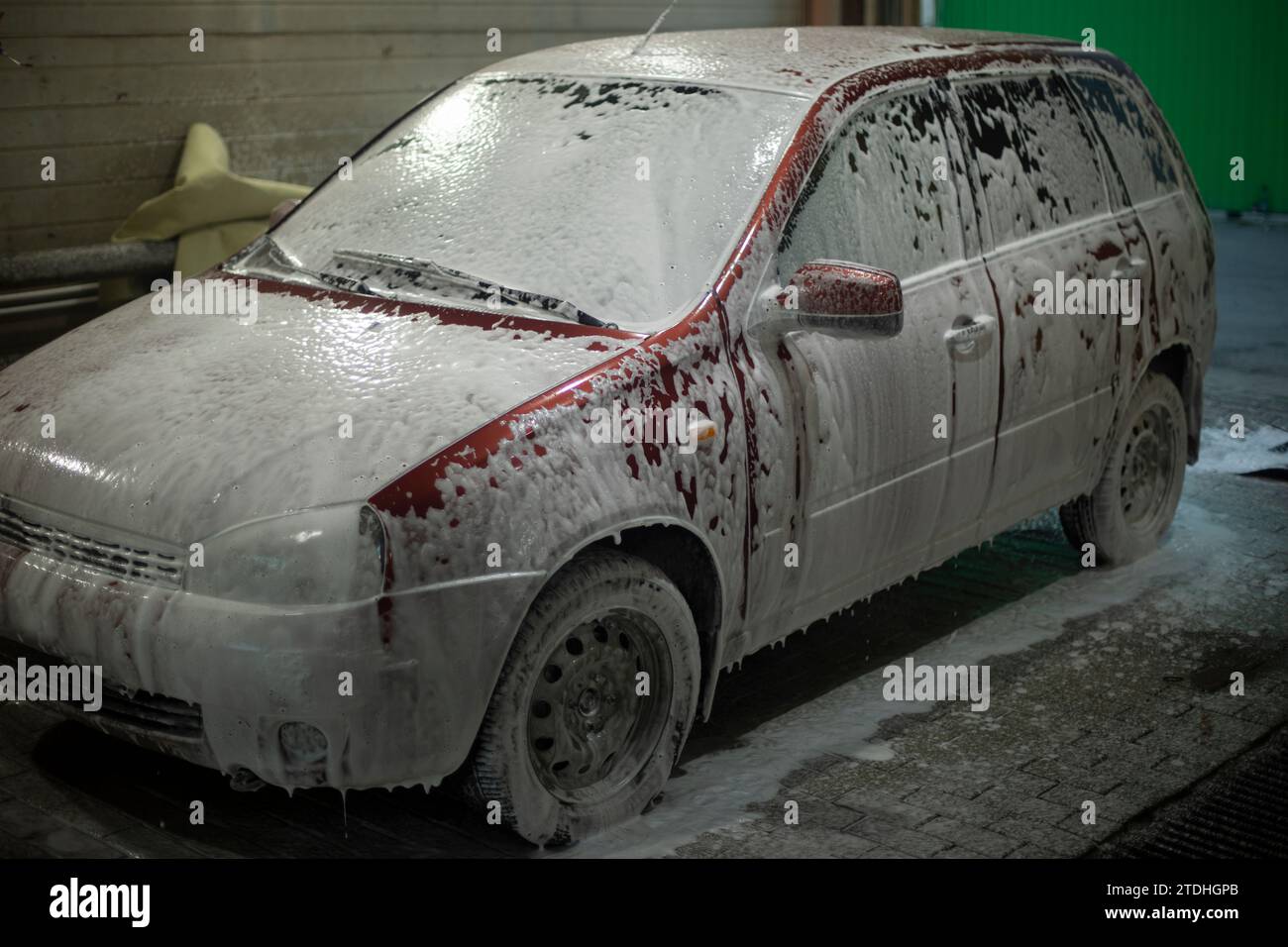 Car at car wash. Soap foam in transport. Washing dirt off machine ...