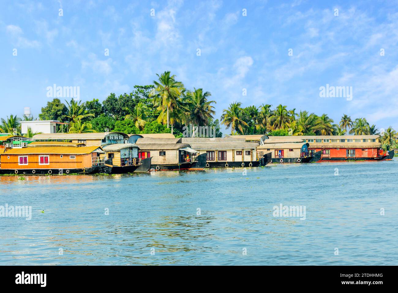 Indian traditional houseboats anchored at Pamba river coastline, with ...