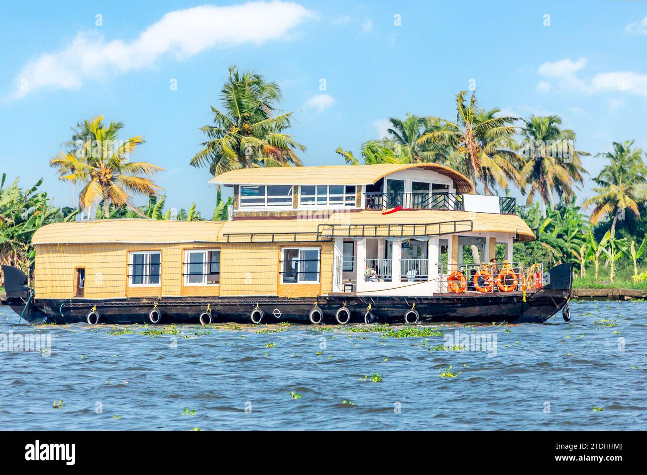 Indian traditional tourist houseboats floating on Pamba river, with ...