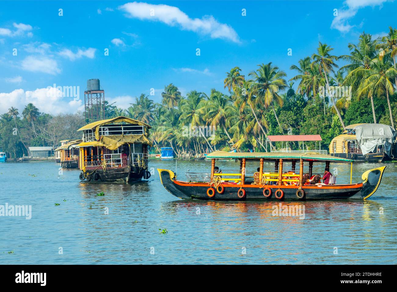 Indian traditional houseboats floating on Pamba river, with palms at ...