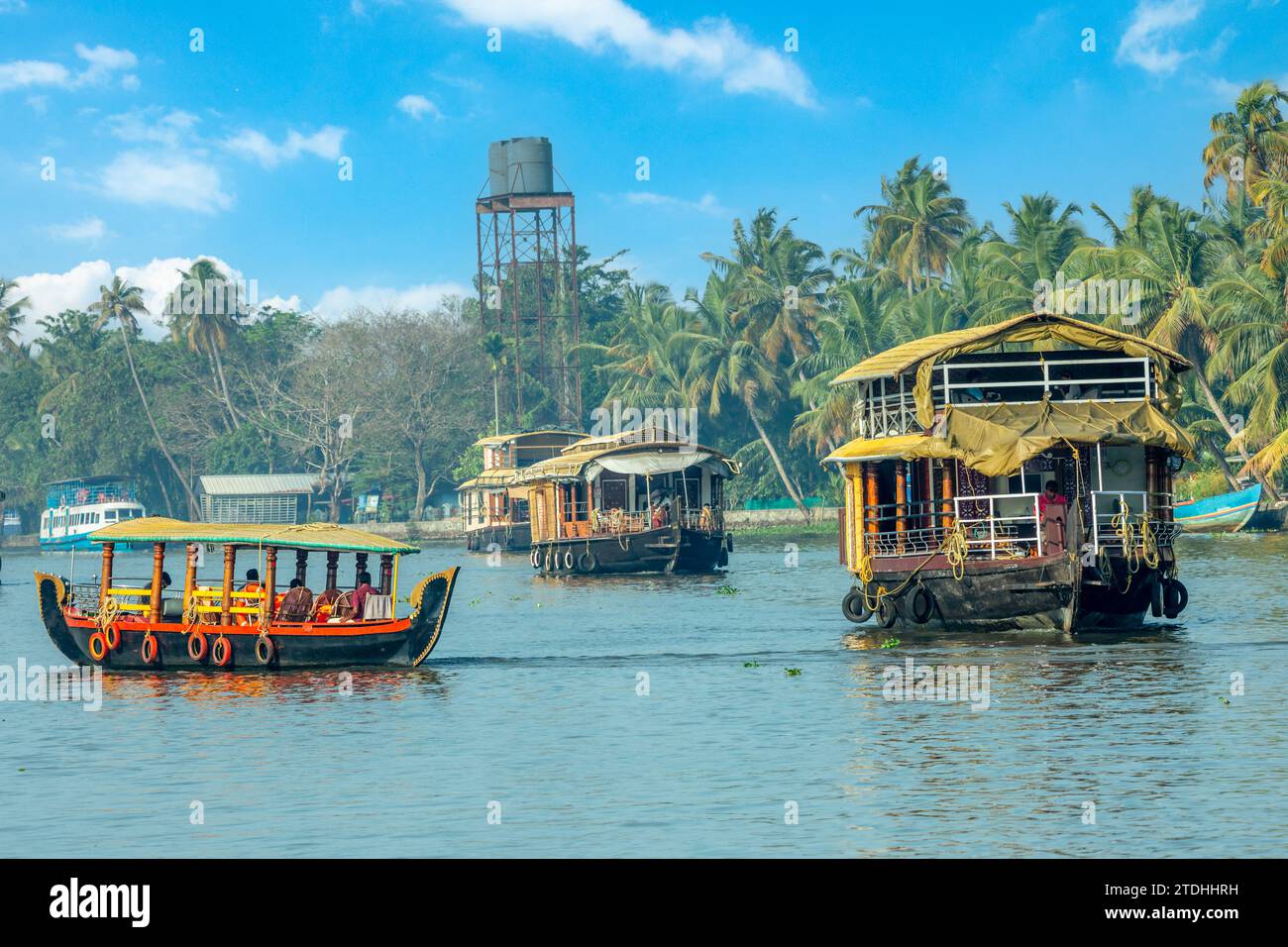 Indian traditional houseboats floating on Pamba river, with palms at ...