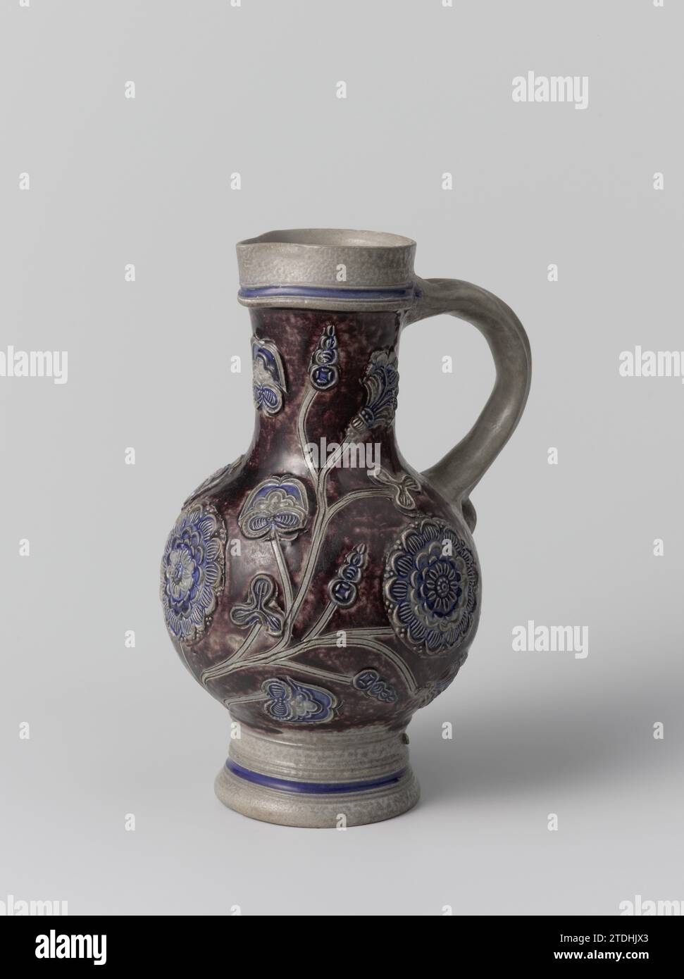 Jug with floral scrolls, anonymous, c. 1680 - c. 1724 Can of stoneware on a high base with a ...