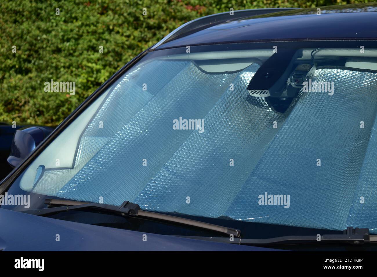 Reflective blanket under the windshield of a car to keep out the heat ...