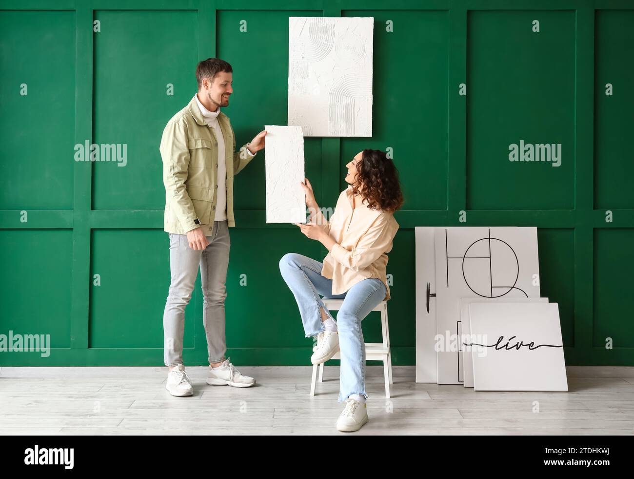 Person hanging paintings hi-res stock photography and images - Alamy