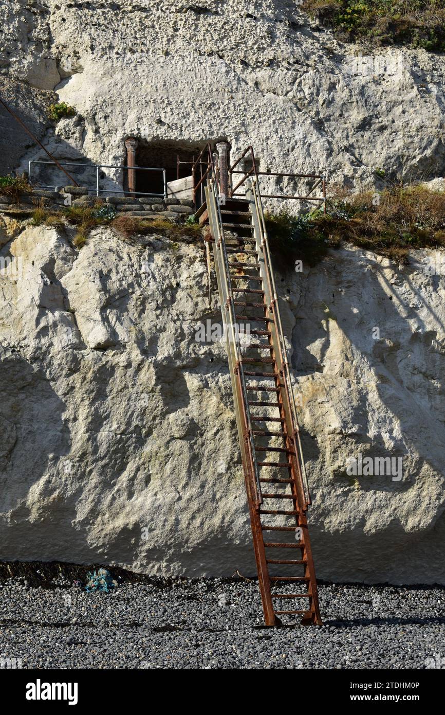 Cave exit inside the white chalk rock of the White Cliffs of Dover and ...