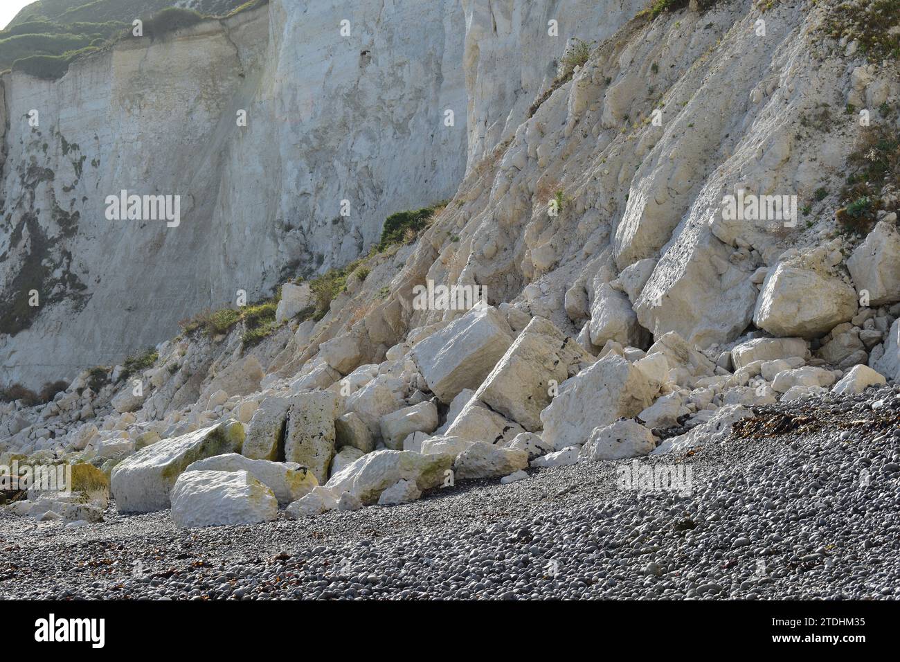 White chalk stone boulders and rocks on the beach at the base of the ...