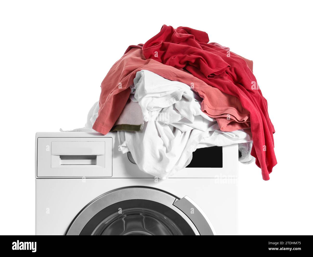 Washing machine with pile of dirty laundry isolated on white background ...