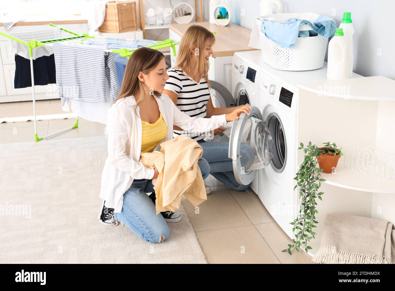 Female students doing laundry in dormitory Stock Photo - Alamy