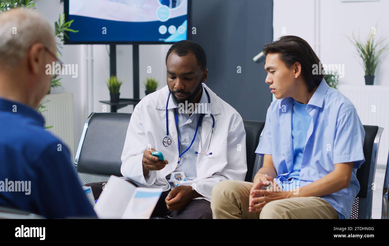 Doctor taking patient insulin level test using medical glucometer ...