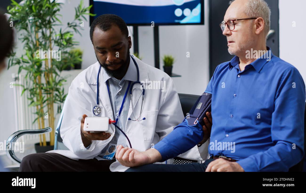 Doctor measuring insulin and glucose level of elderly patient using ...