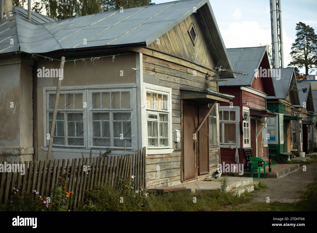 House in ghetto. Poor neighborhood in city. Hut made of planks. Windows ...
