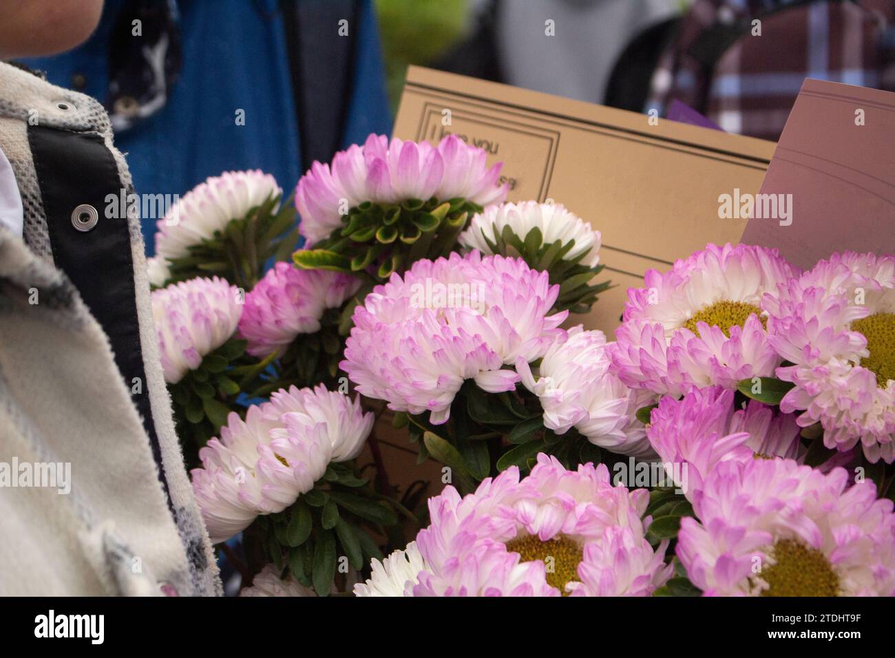 Flowers as gift. Bouquet of flowers at festival. Student brought ...