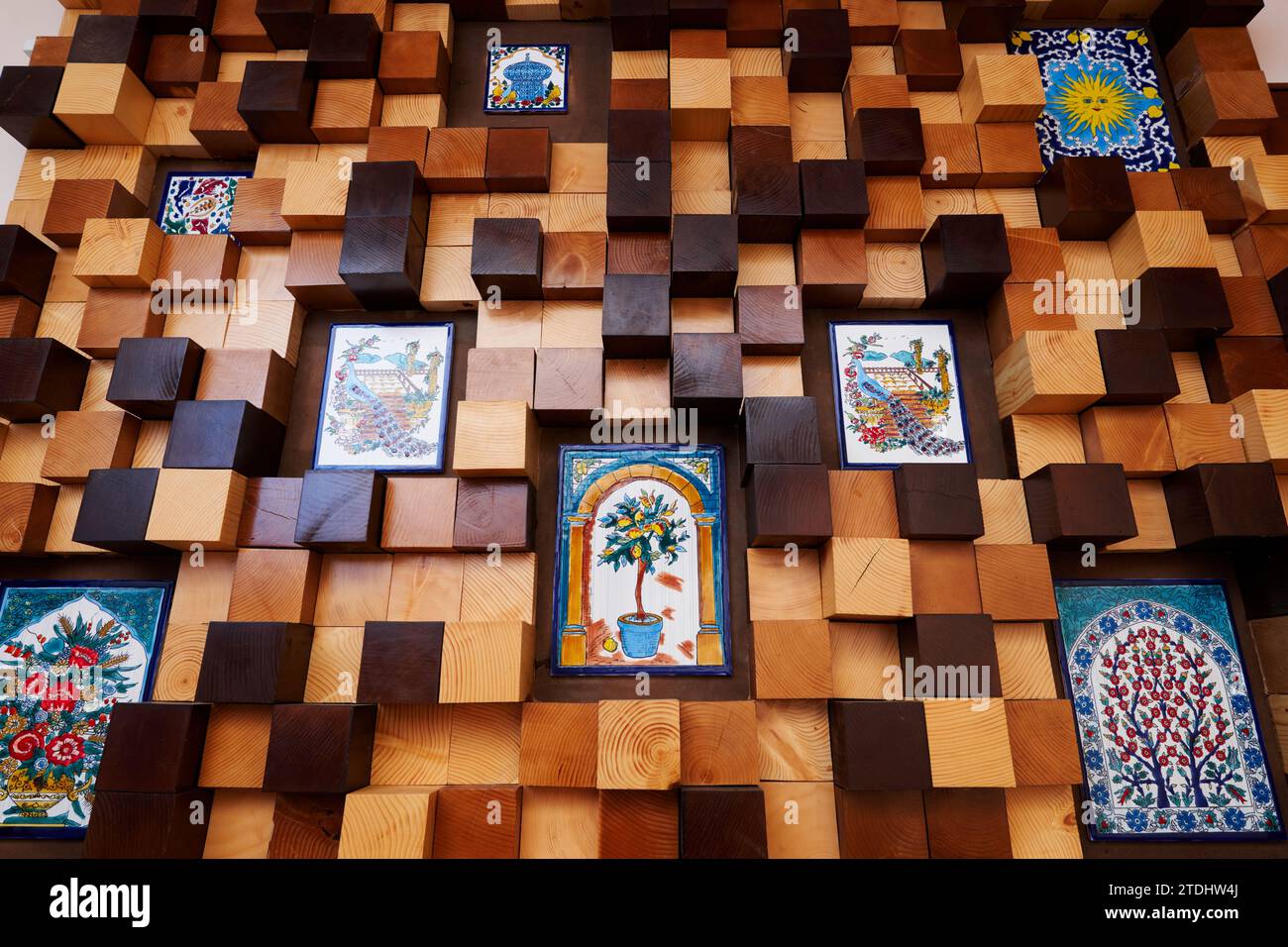 Wooden panel of light and dark cubes with inserts of colorful paintings ...
