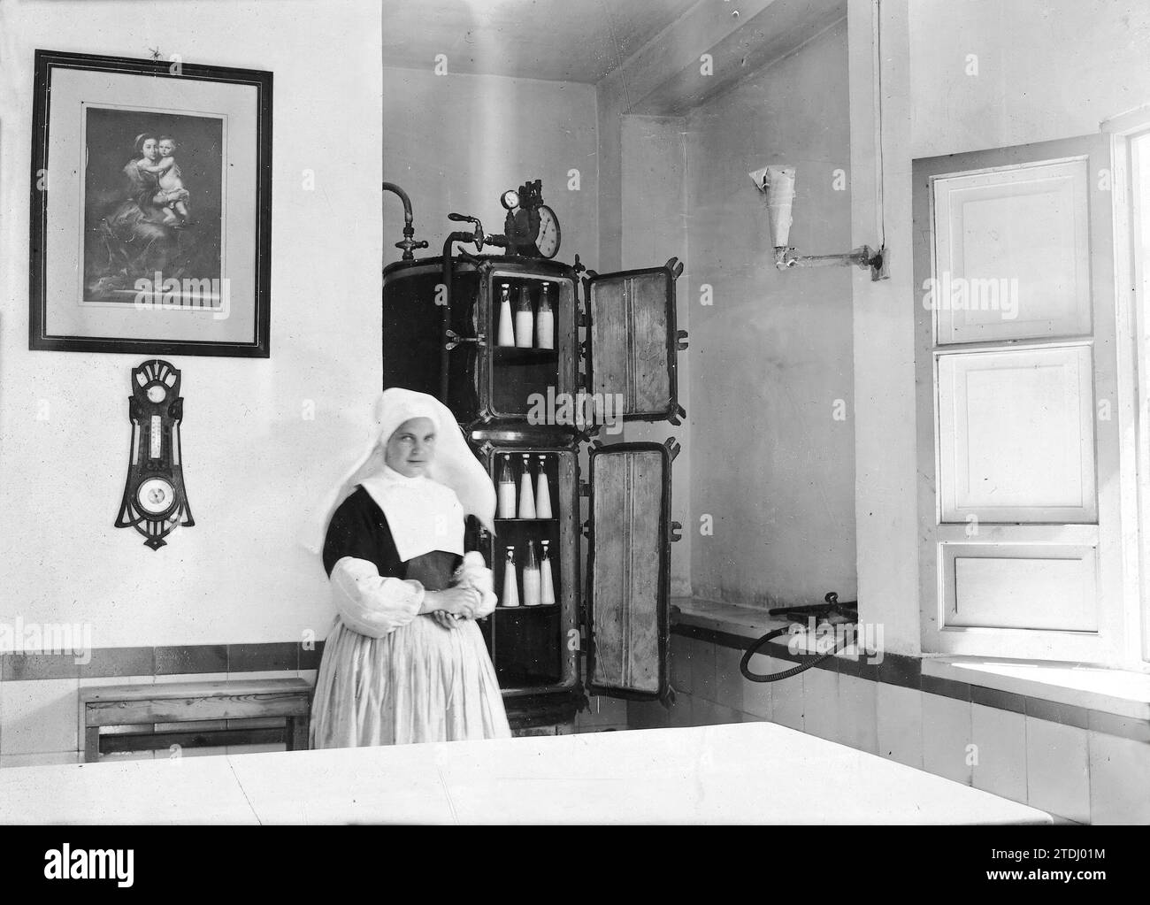 Seville, October 1909. A nun in the milk sterilization department of ...