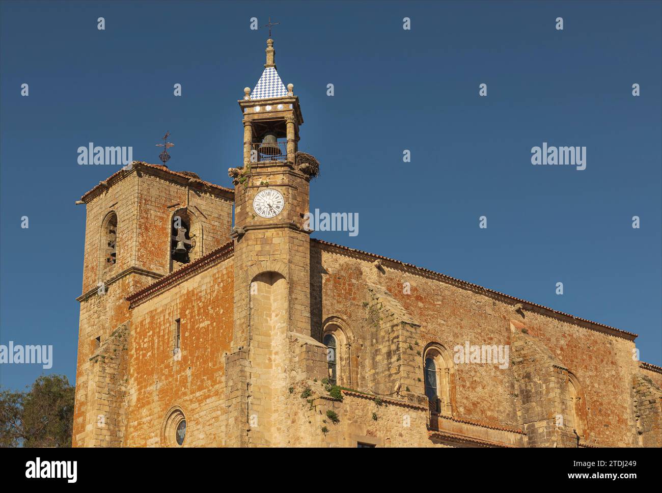 Tall historic bell tower of an ancient church with a blue and white ...