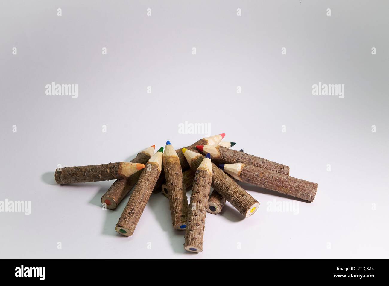 Original colored pencils, made with tree branches of the same size on a ...