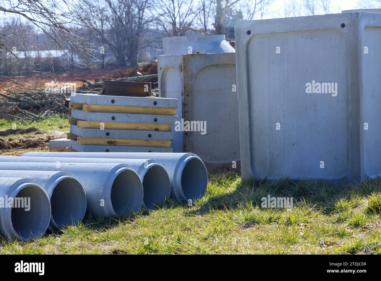 Stacks of concrete drainage pipes, manhole are awaiting installation at ...