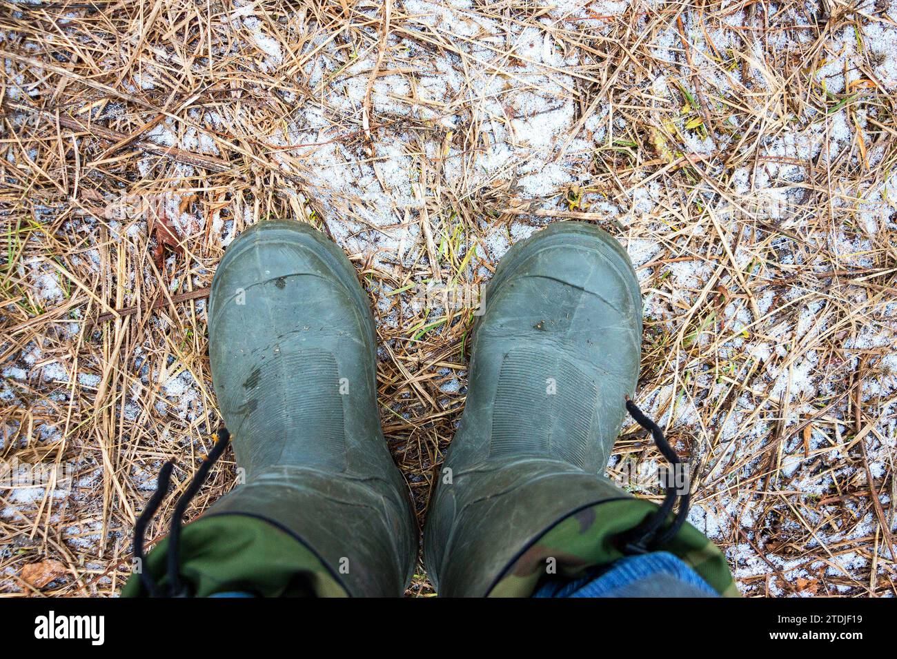 Feet in boots on the frozen ground. View from above Stock Photo - Alamy