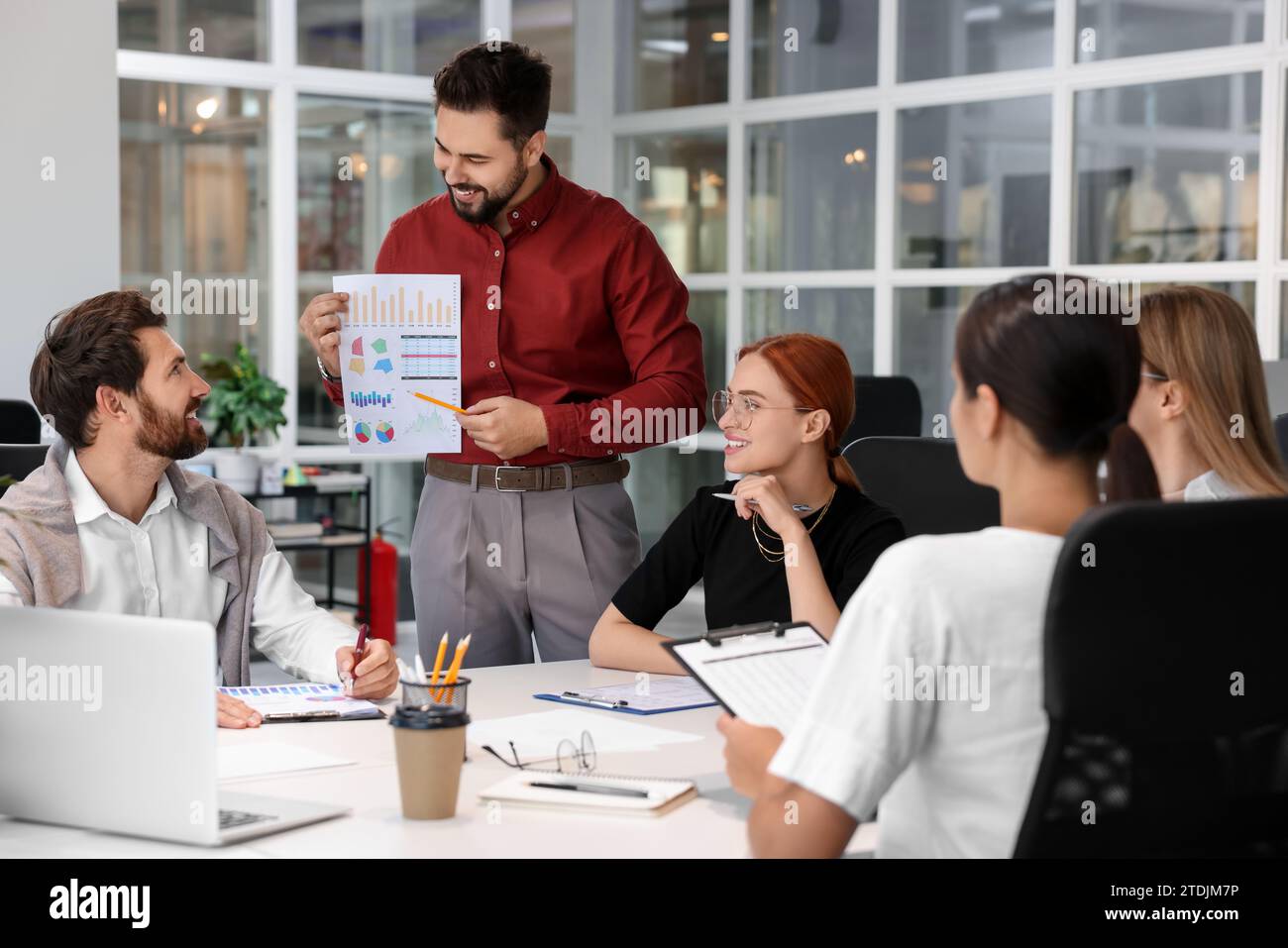 Team of employees working together in office Stock Photo - Alamy