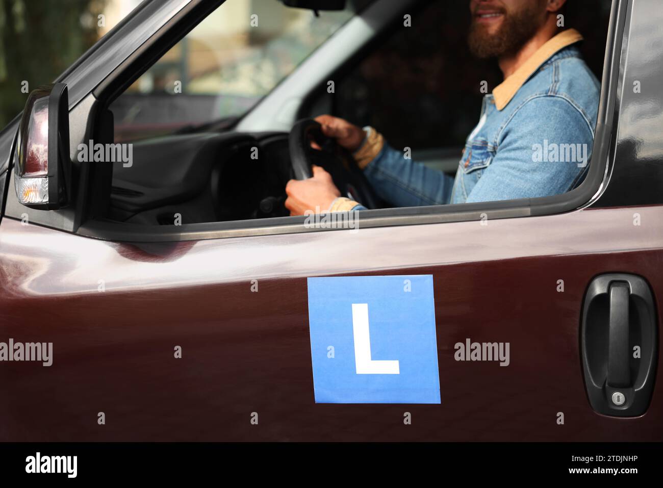 Learner driver driving car with L-plate, view from outside. Driving ...