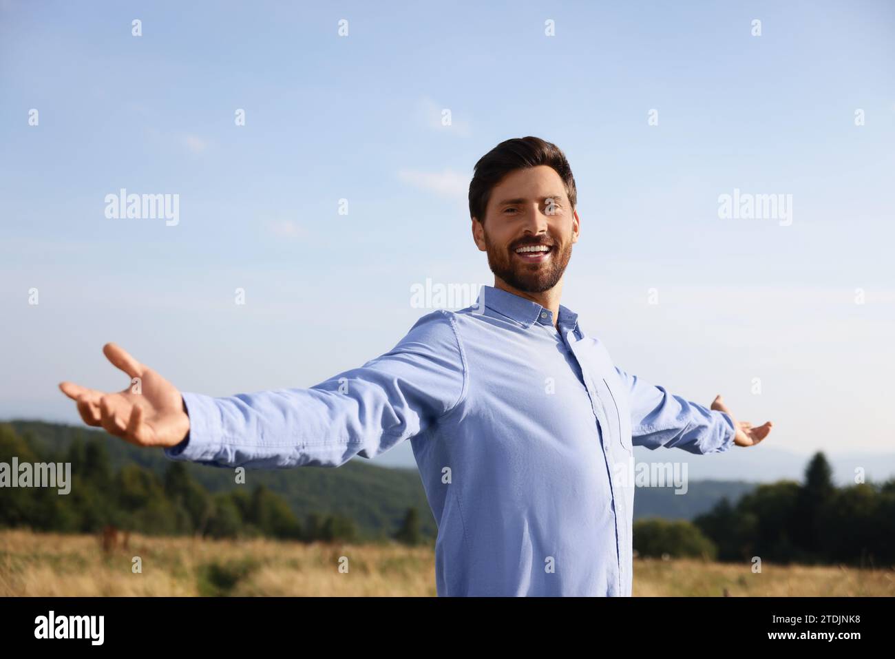 Feeling freedom. Happy man with wide open arms on meadow Stock Photo ...