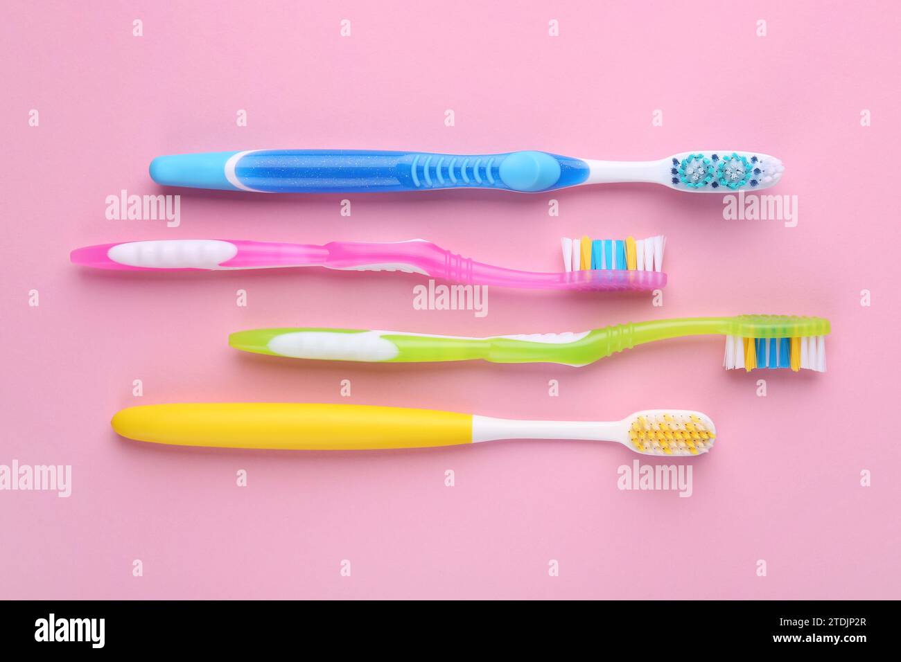 Many different toothbrushes on pink background, flat lay Stock Photo ...