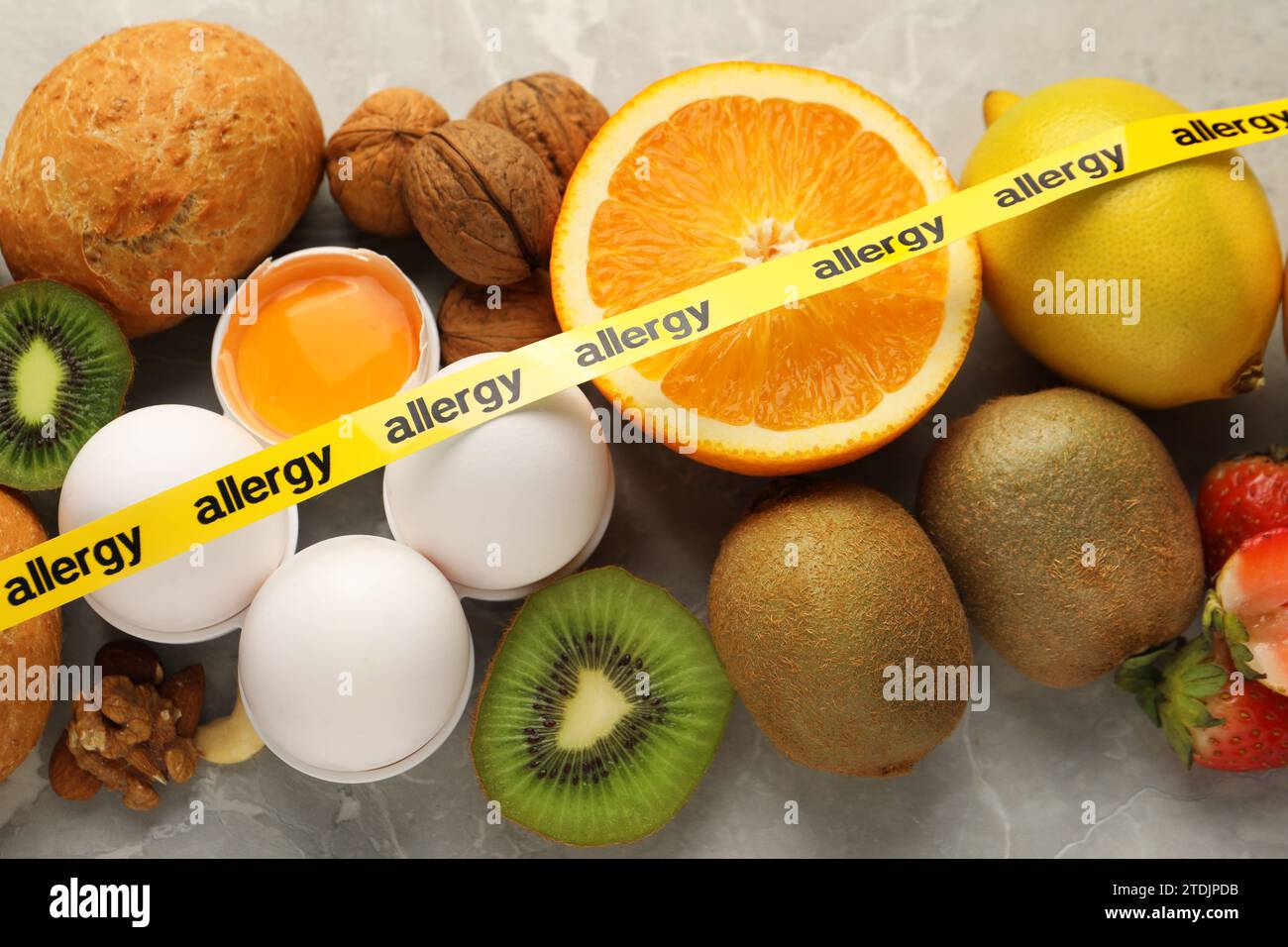 Allergenic food. Different fresh products with tape on table, top view ...