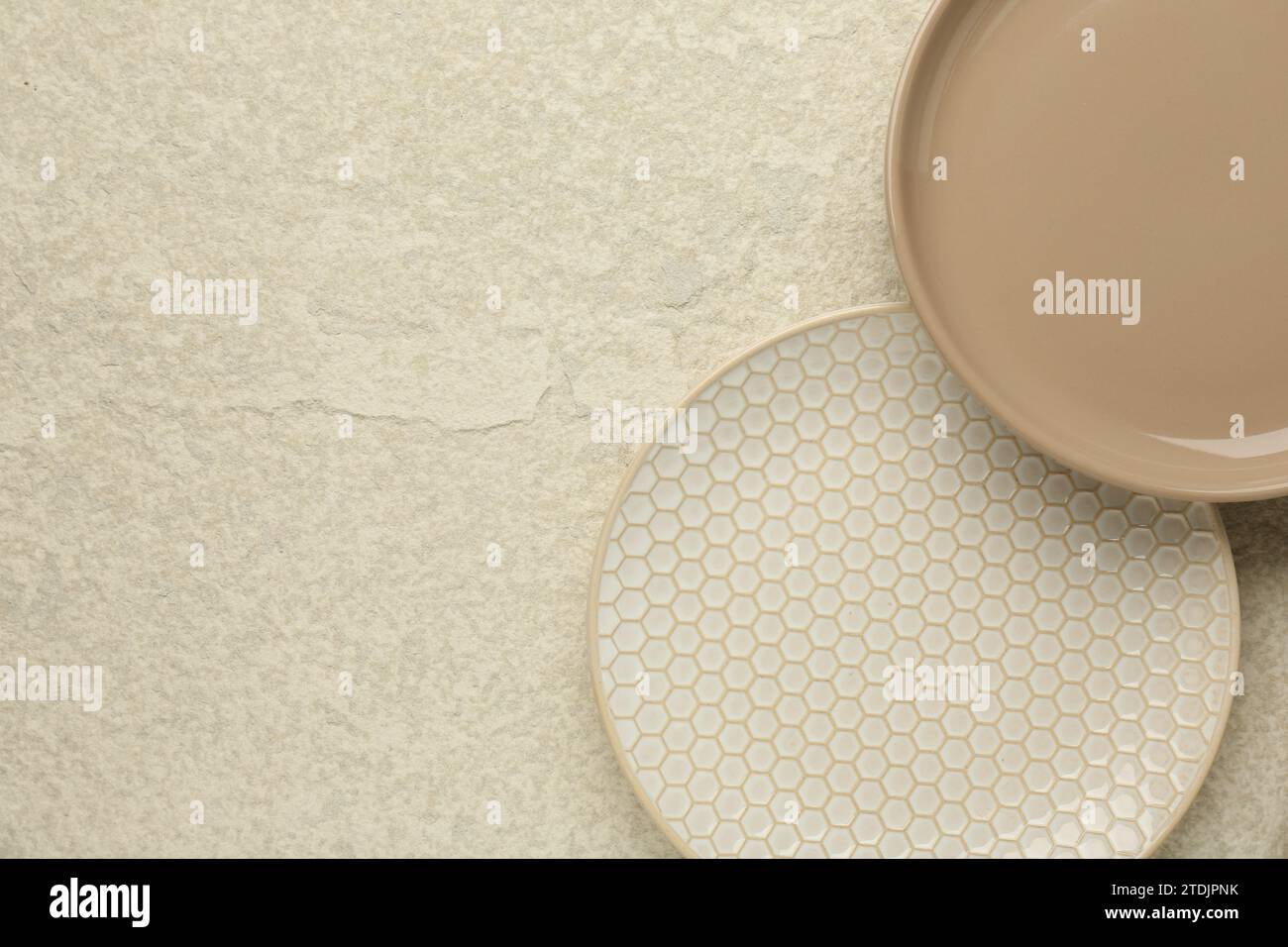 Beautiful ceramic plates on beige table, top view. Space for text Stock ...