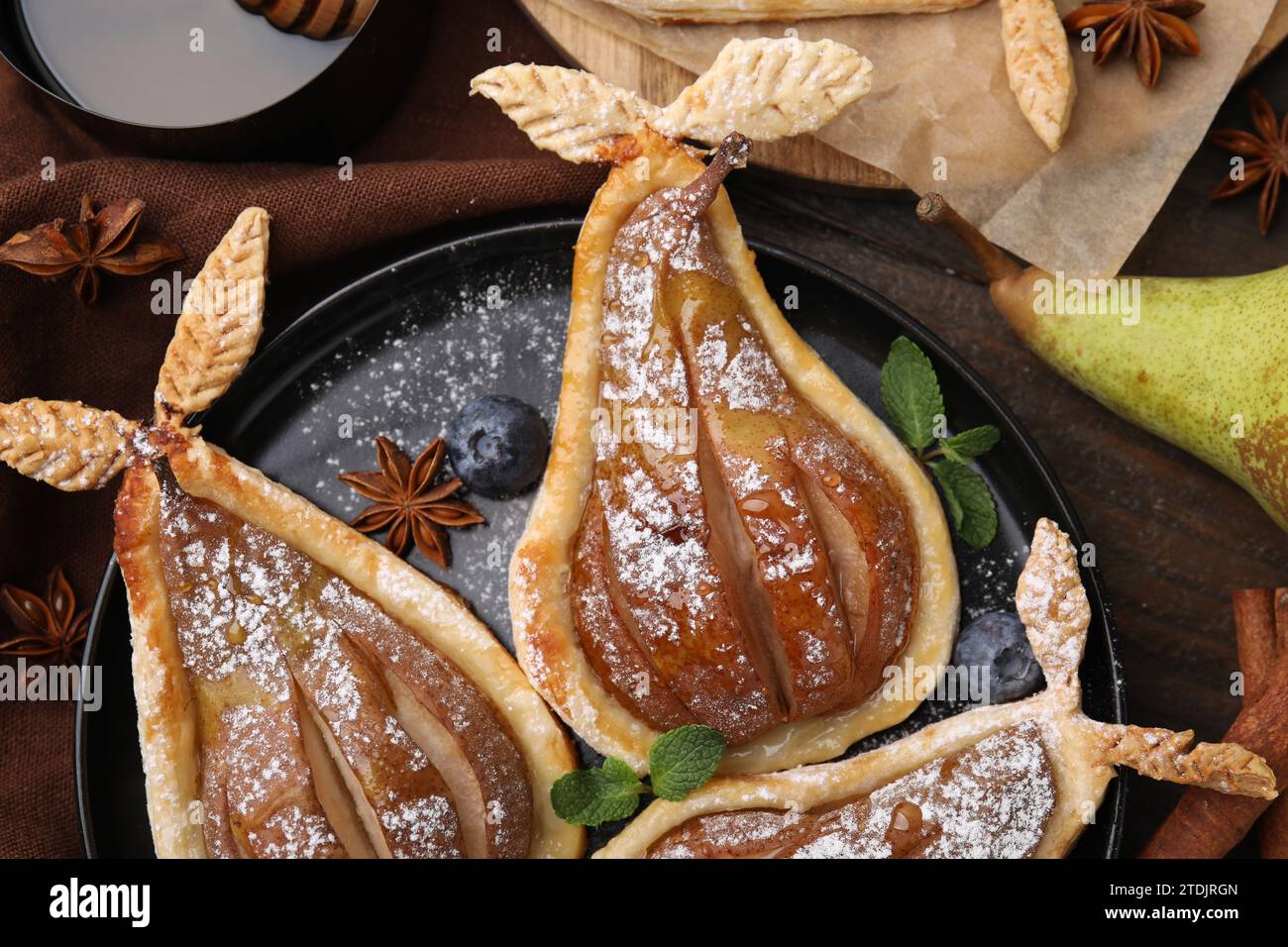 Delicious pears baked in puff pastry with powdered sugar served on ...