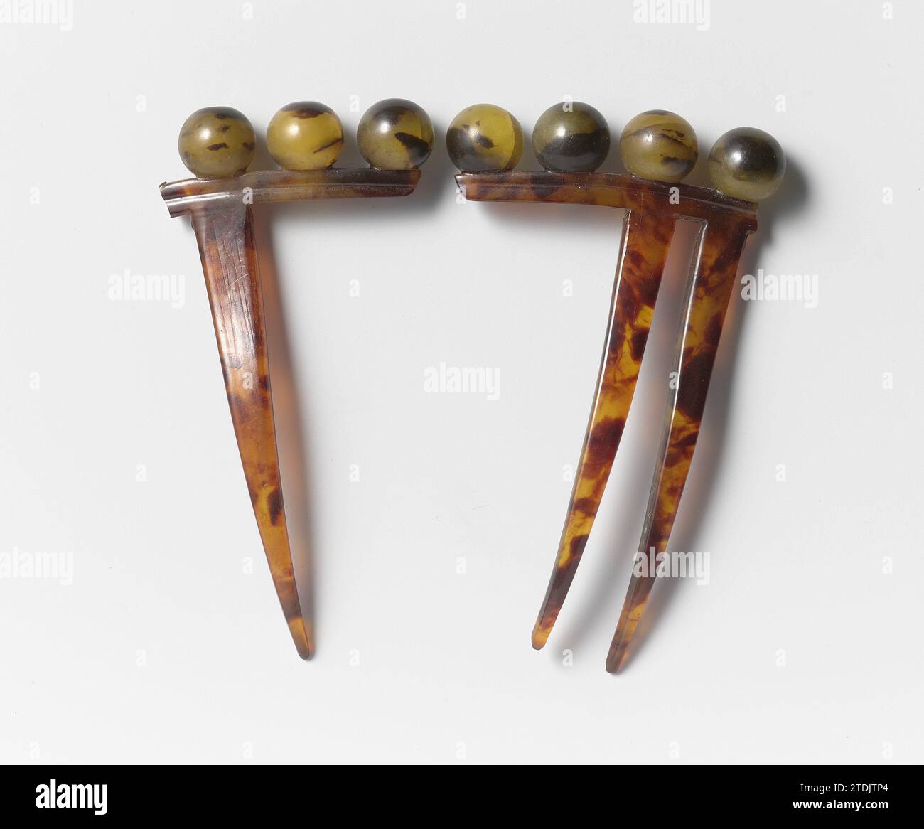 Hair comb of imitation turtle or horn with narrow back on which five ...