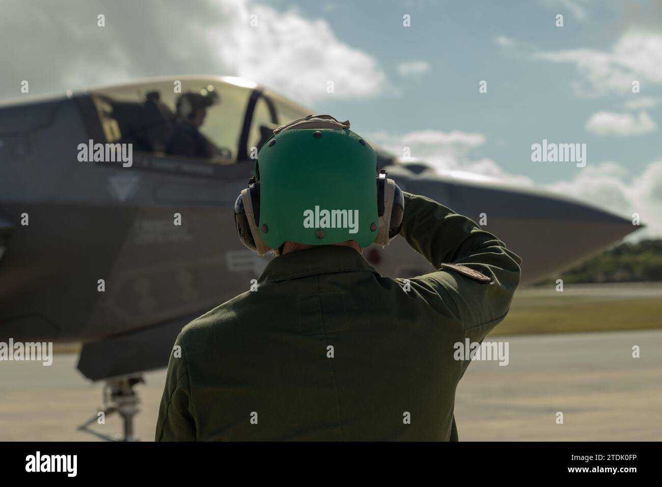 A U.S. Marine with Marine Wing Support Squadron (MWSS) 174 assists with ...