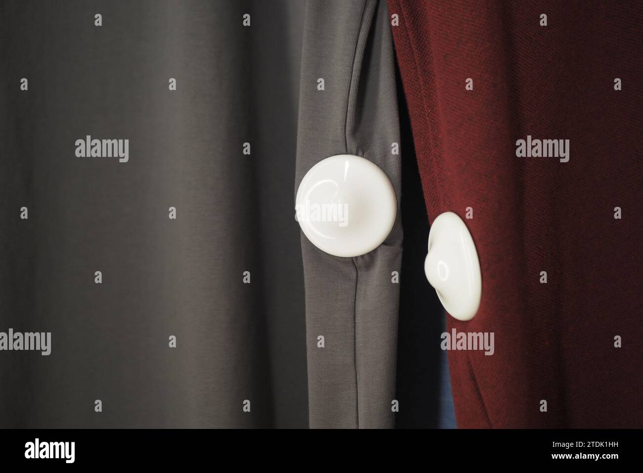 Clothing security tag on a shirt Stock Photo - Alamy