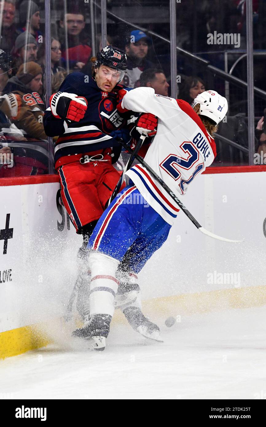 Montreal Canadiens' Kaiden Guhle (21) checks Winnipeg Jets' Mason ...