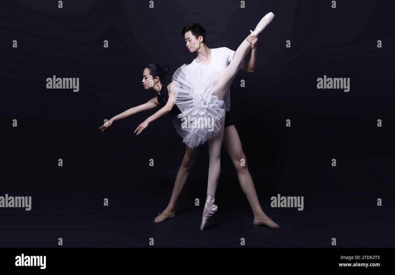 Couple dancing ballet in the dark studio Stock Photo - Alamy